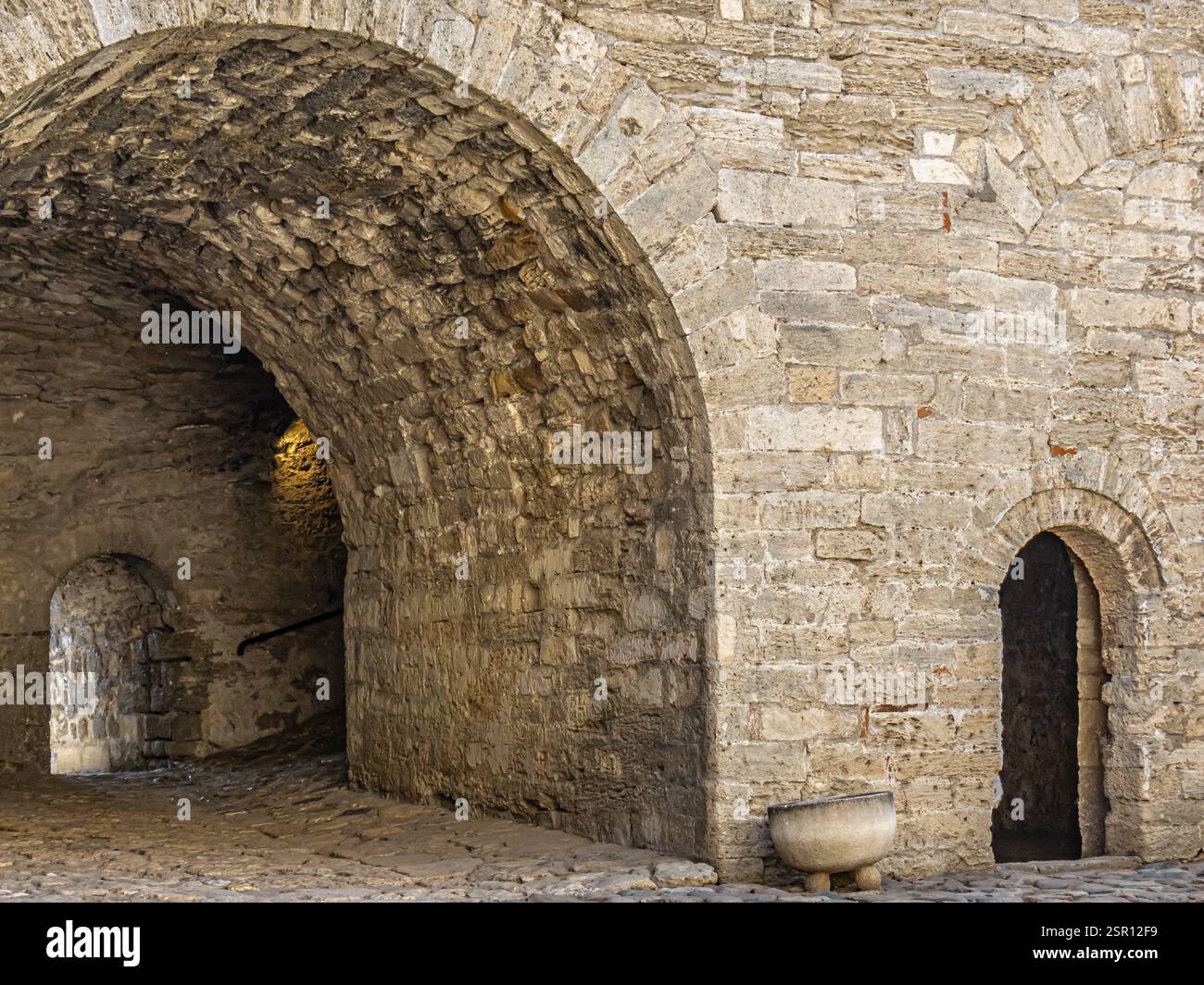This location features a rustic stone structure with a large archway ...