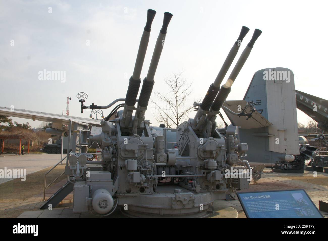 Anti-aircraft guns. Four barrels point skyward. Radar dish atop ...