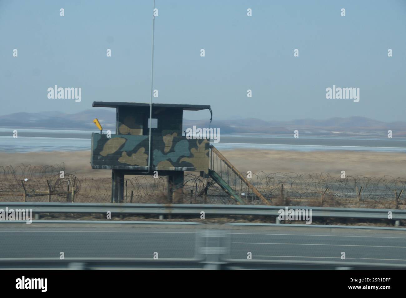 Guardhouse, barbed wire, watchtower, and camouflage. Border protection ...