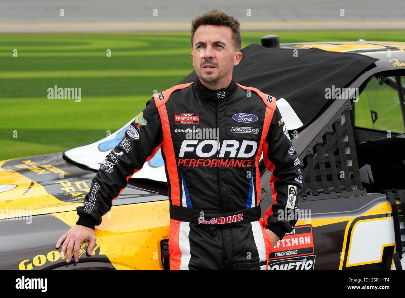 Actor turned race car driver Frankie Muniz leans against his truck ...