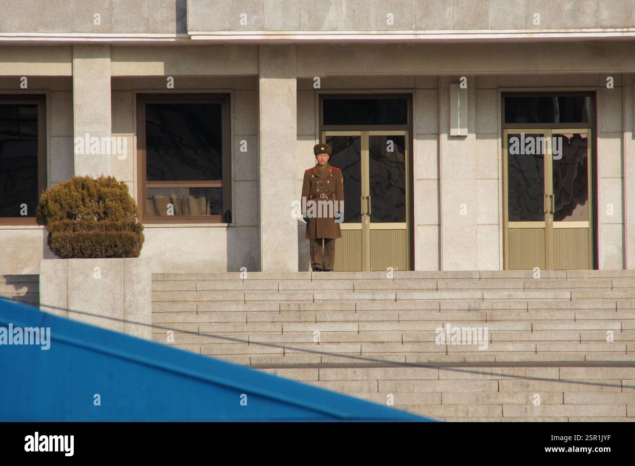 North Korean soldier guarding border. Green uniform, beret. North ...