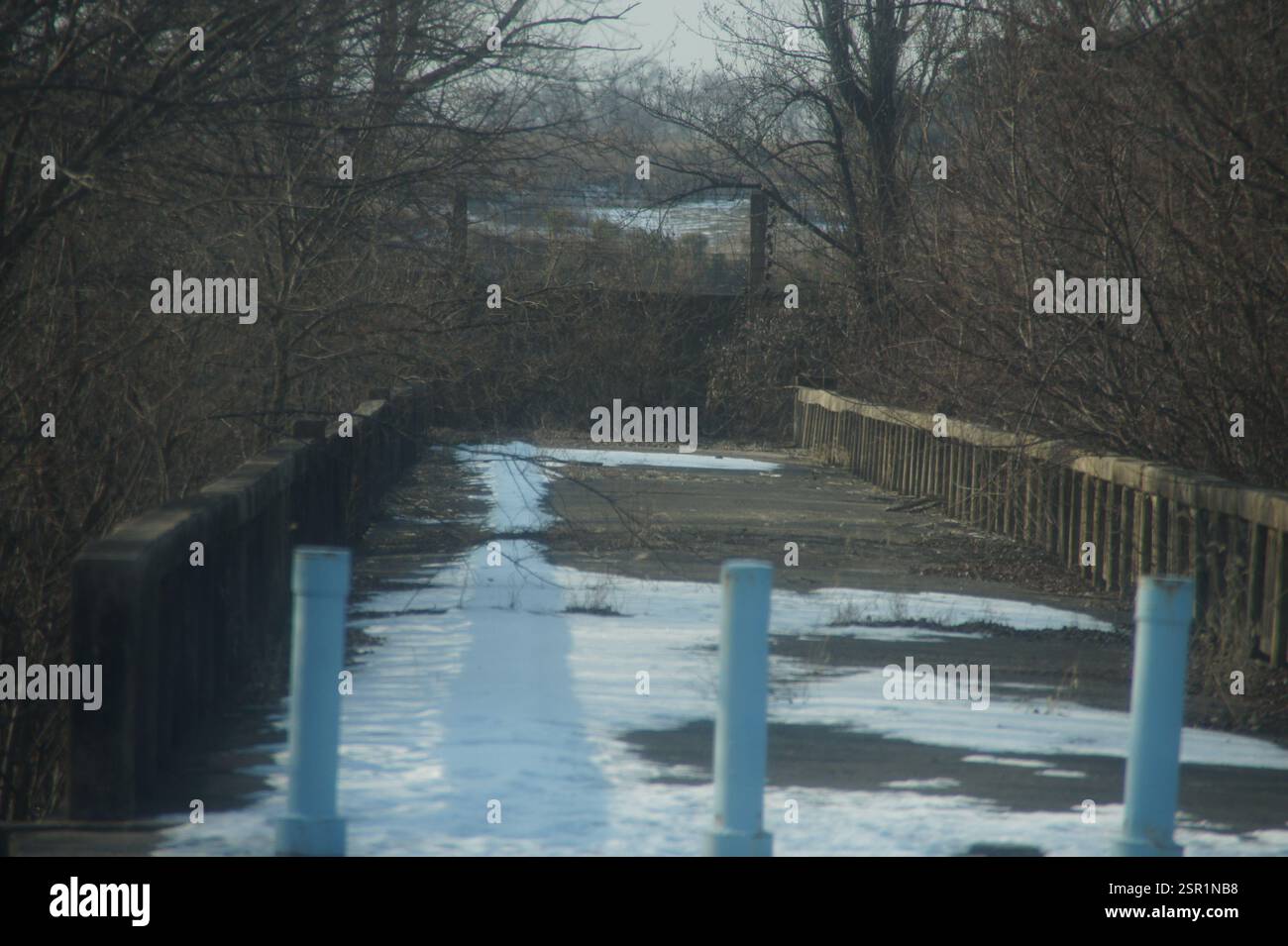 Dilapidated bridge in South Korea with snow. Weathered wooden railings ...