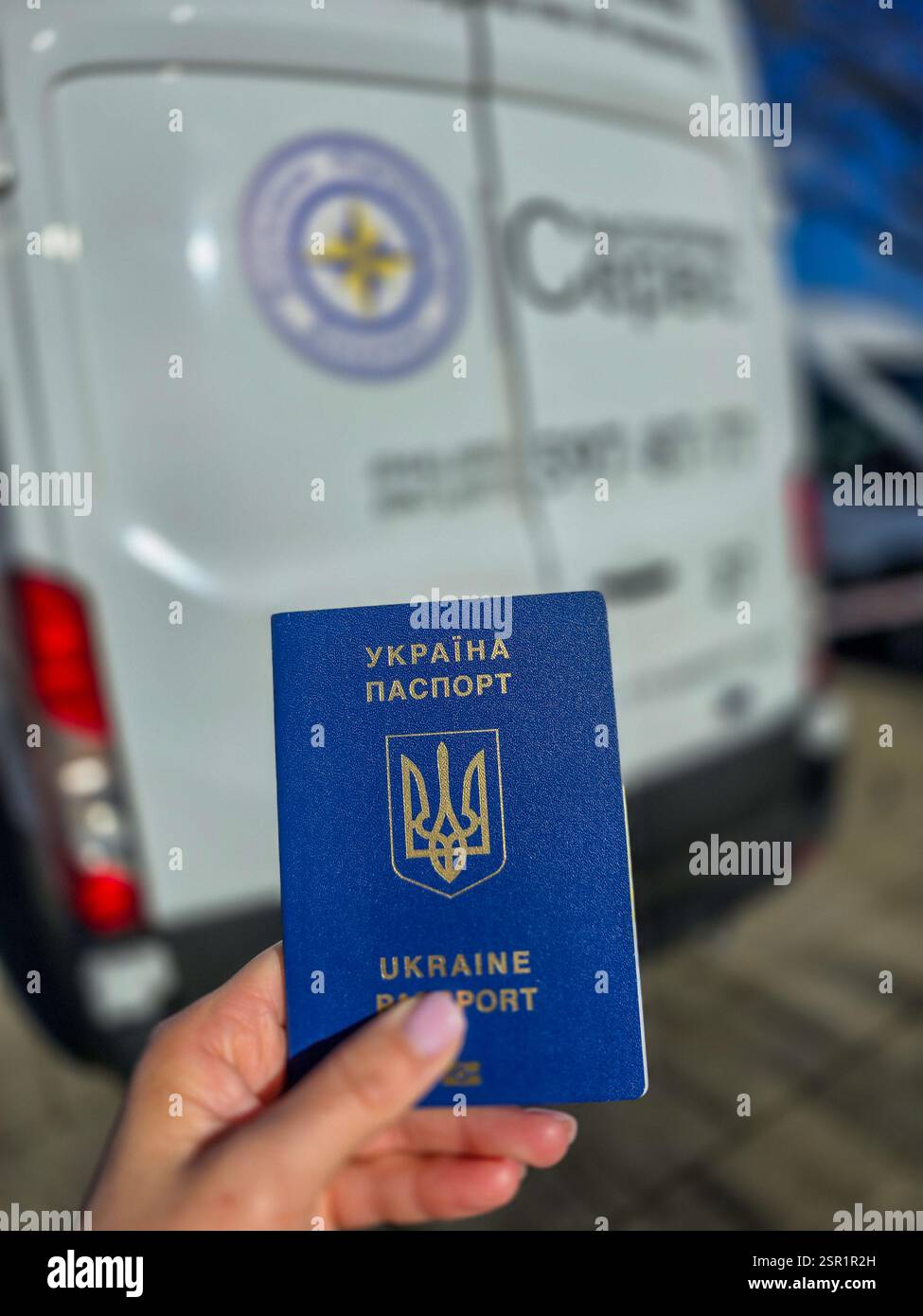Ukrainian international biometric passport in the female hand, against ...