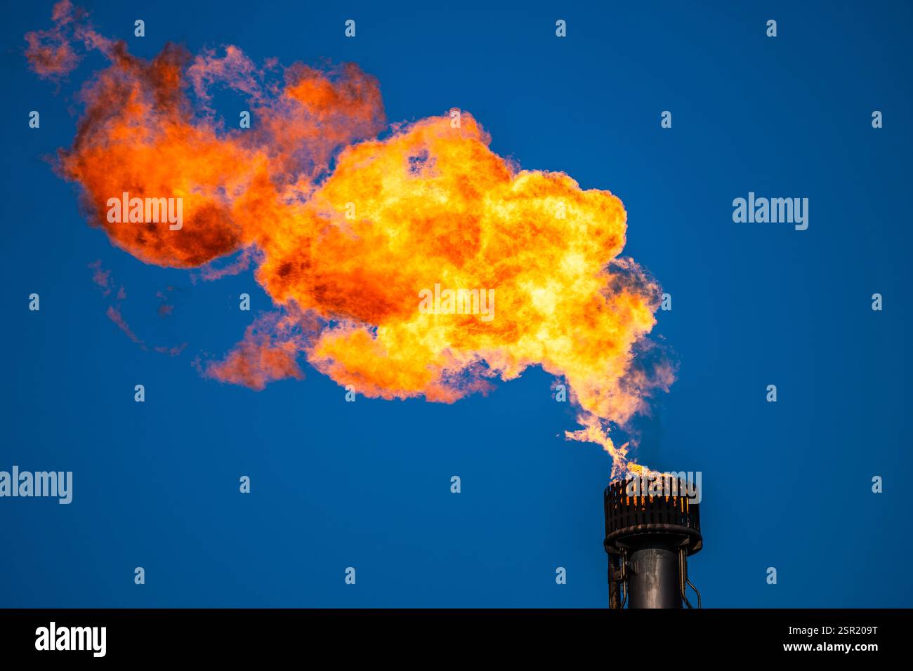 Flame burning off bi-product hydrocarbons at an oil refinery Stock ...