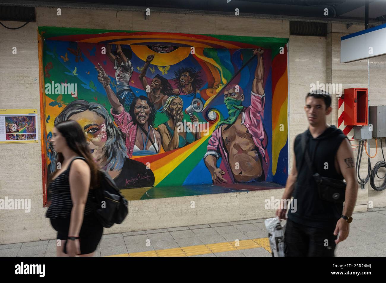 Commuters walk past a mural depicting a LGBTIQA+ street demonstration ...