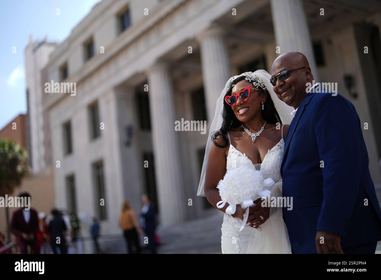 Newlyweds Tamare and Delroy Burgess pose for pictures after getting ...