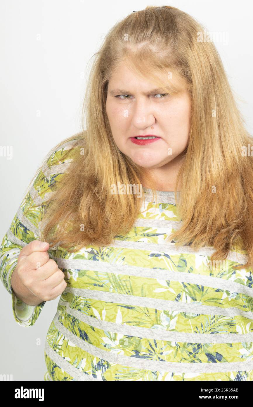 Close-up portrait of a mature plus-size woman with blonde hair and ...