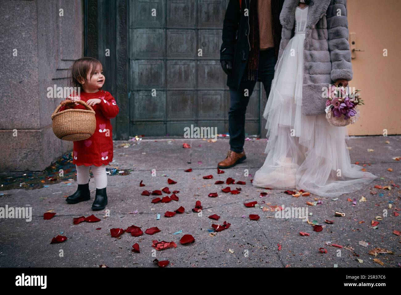Newlyweds Kareen Matadeen and Nicholas Stillman walk on the rose petals ...