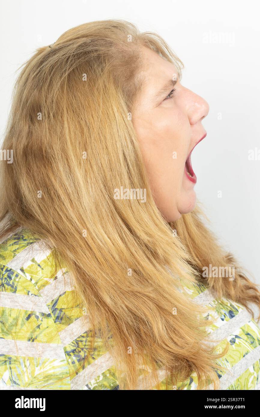 Side profile of a mature plus-size woman with blonde hair and green ...