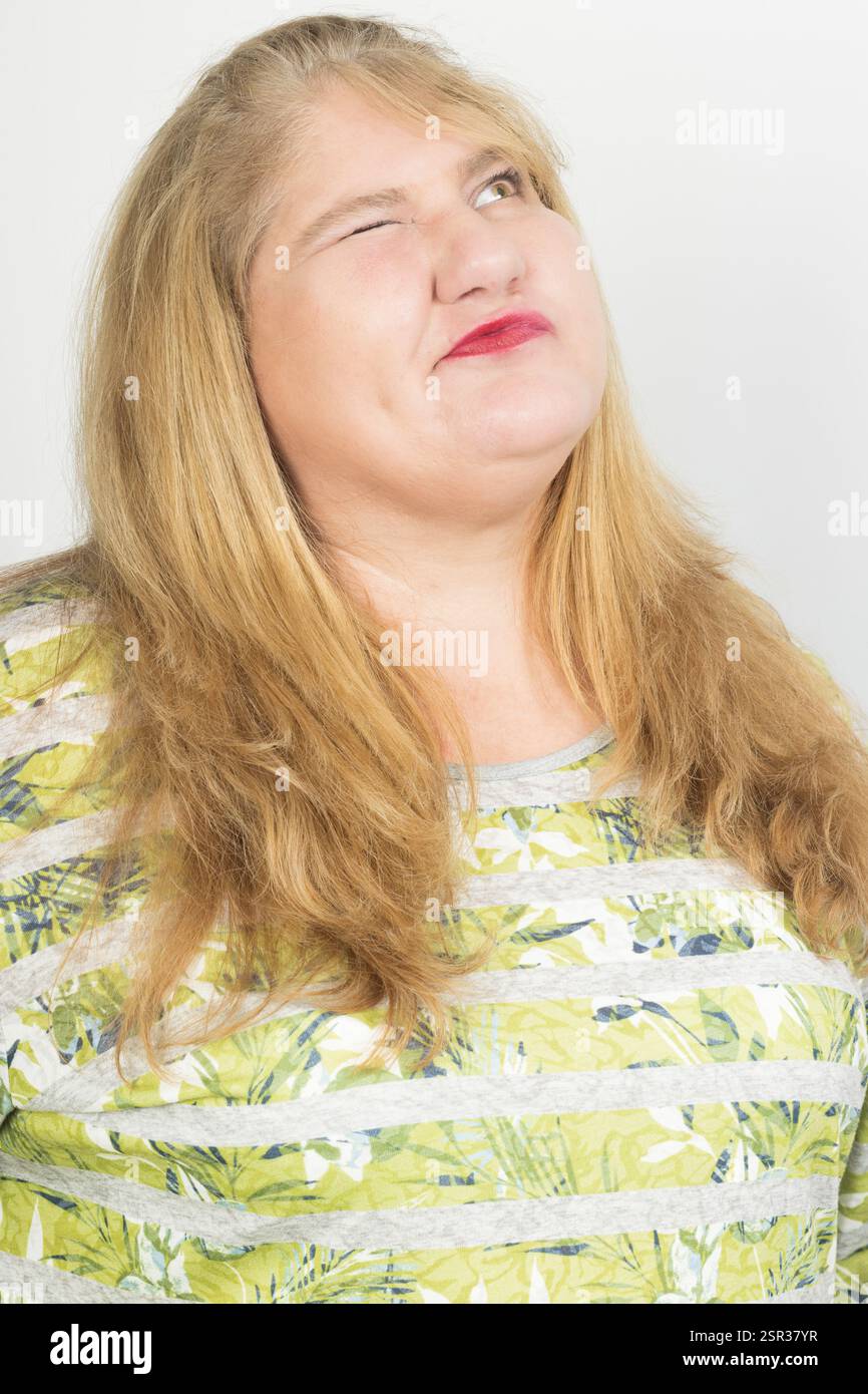 Portrait of a mature plus-size woman with blonde hair and green eyes ...