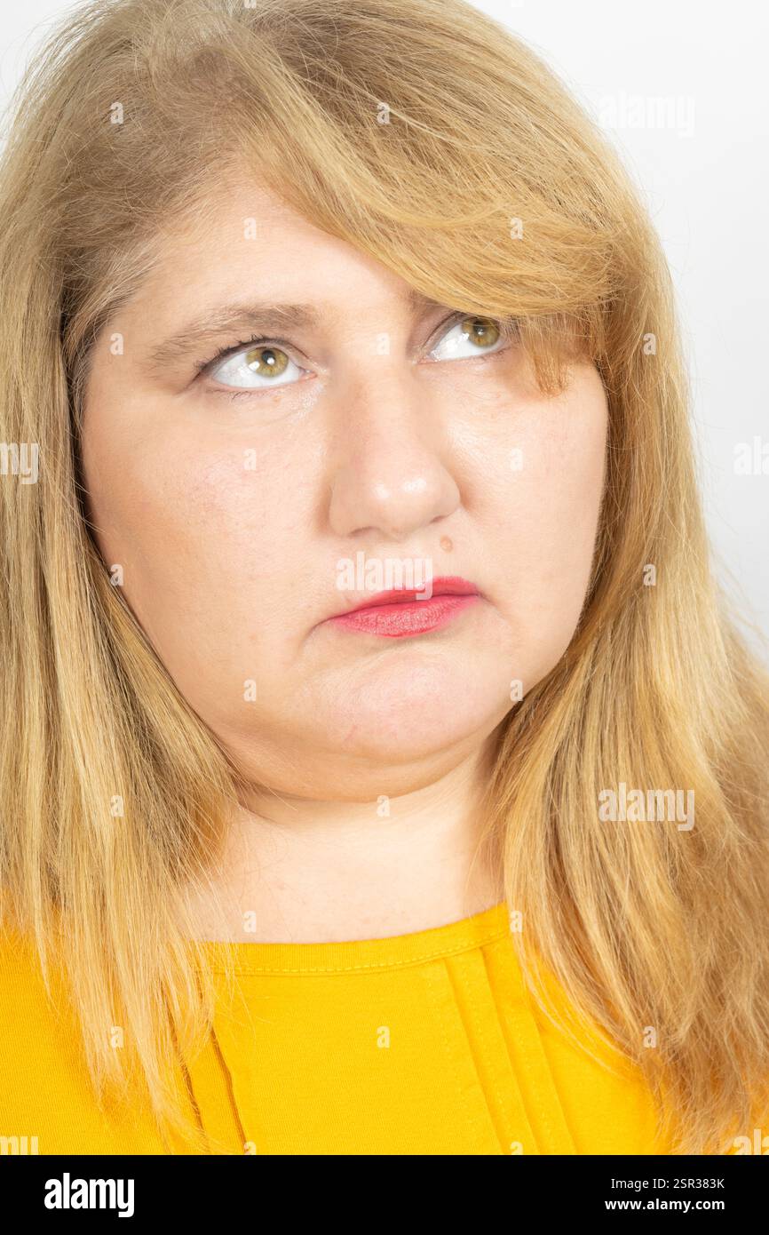 Close-up portrait of a mature plus-size woman with blonde hair and ...
