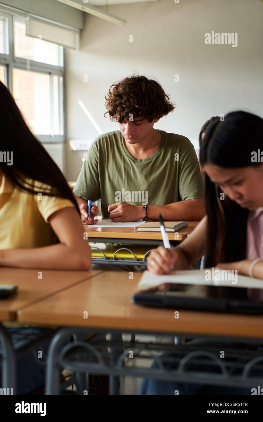 Focused students writing exam in classroom at high school Stock Photo ...