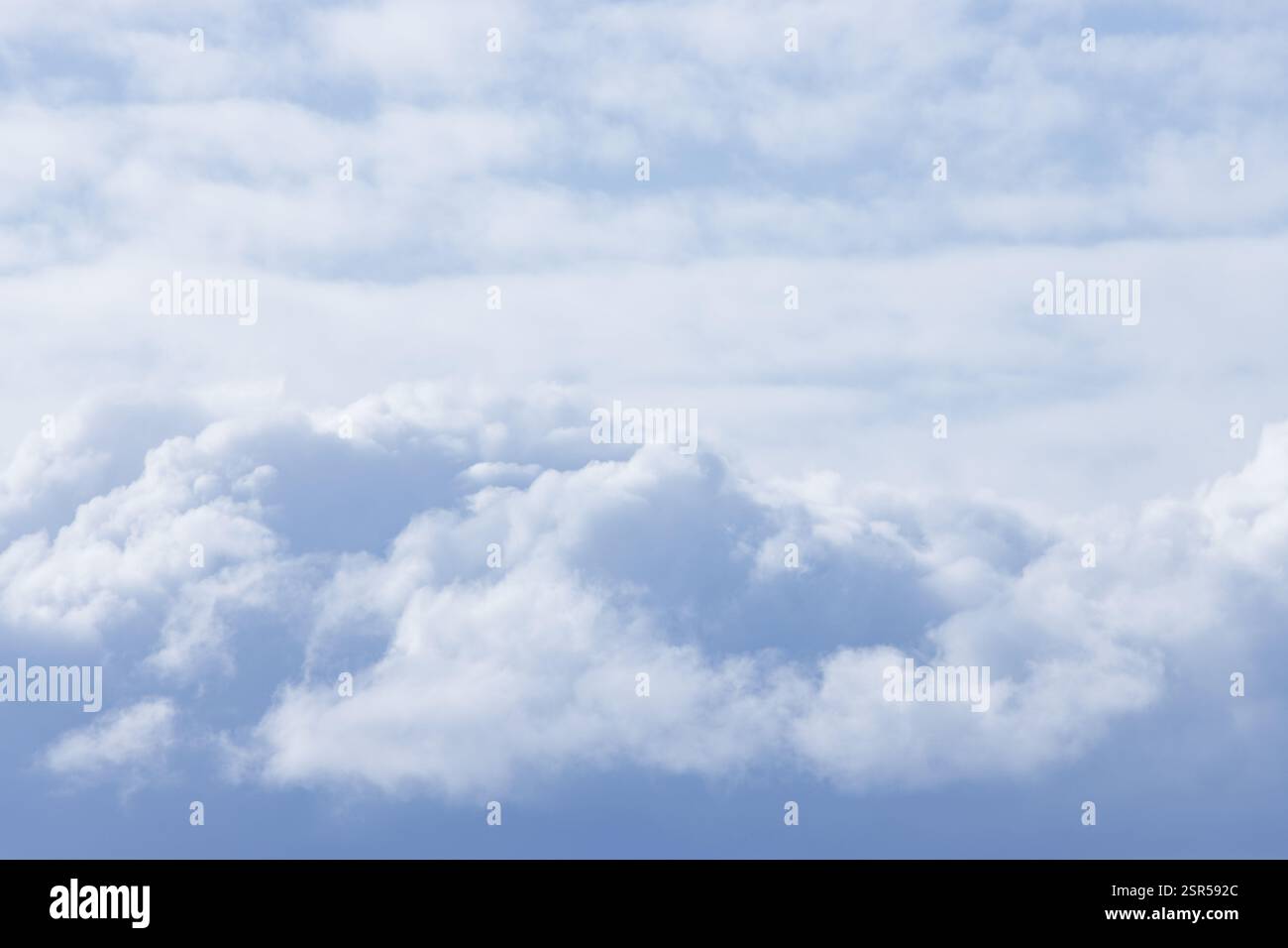 Soft white flurry clouds in a pale winter sky textured background Stock Photo - Alamy