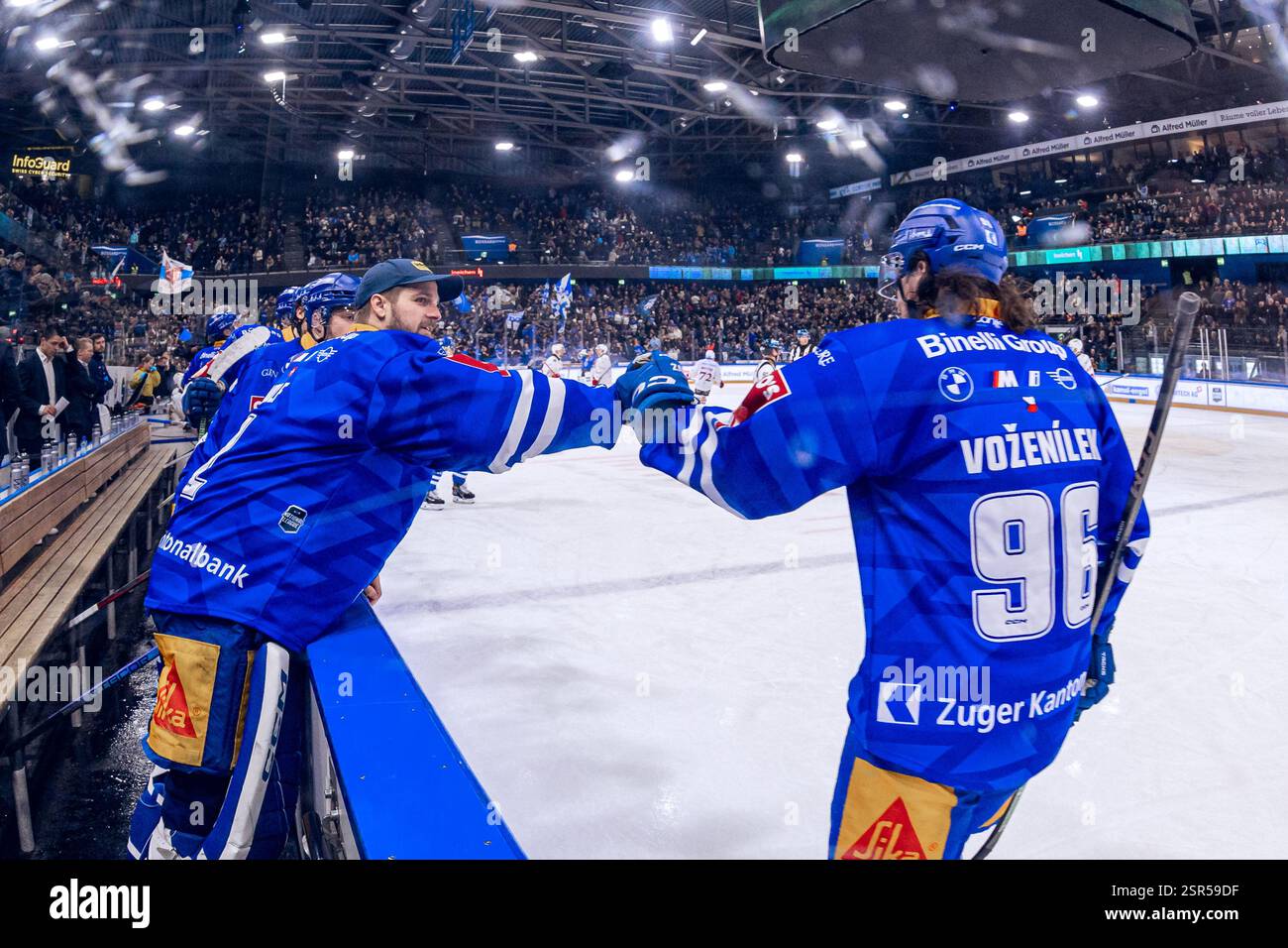 Goalkeeper Tim Wolf #1 (EV Zug) congratulates Daniel Vozenilek #96 (EV ...