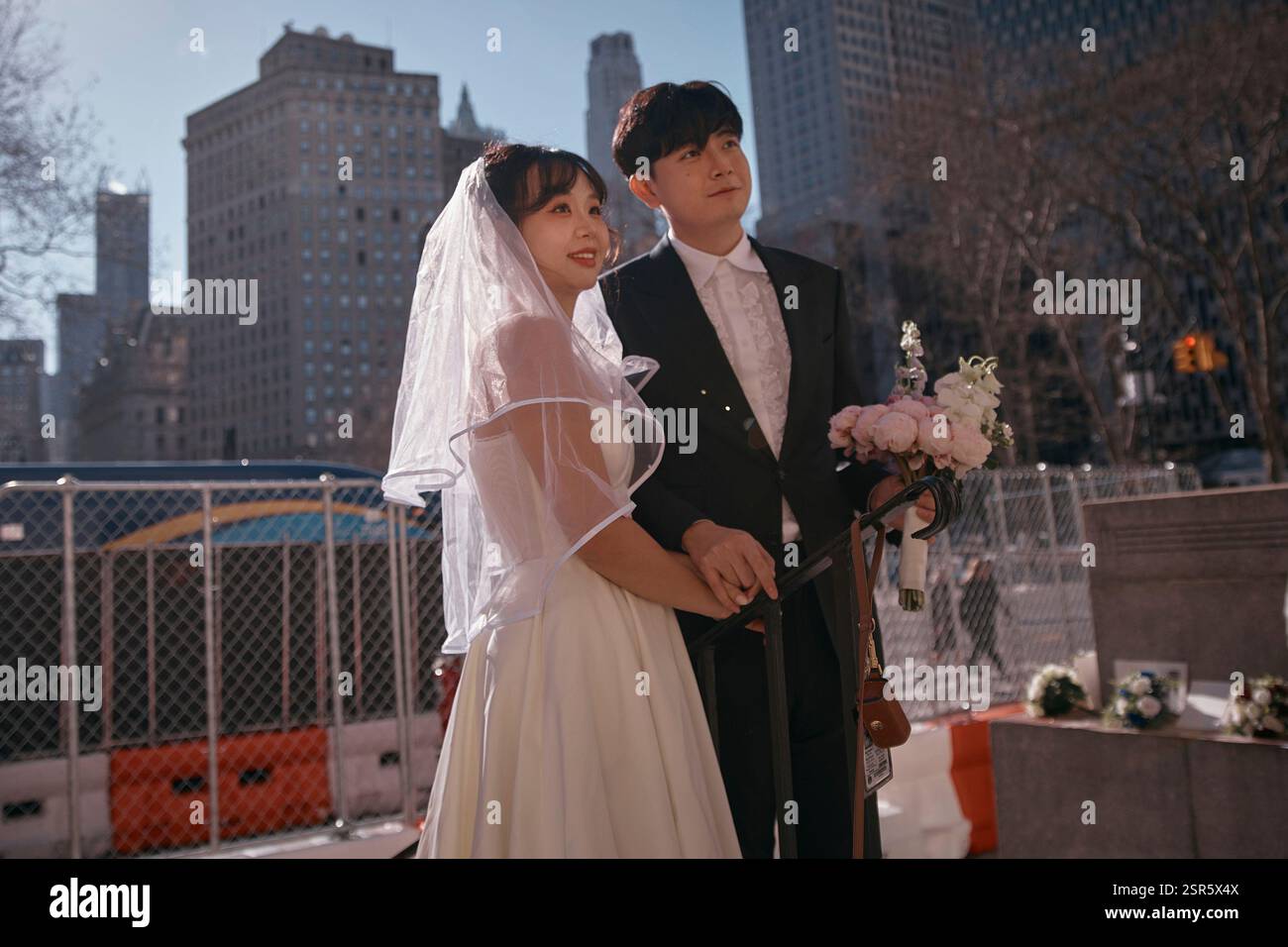 A couple poses for a photographer as they arrive to get married outside ...