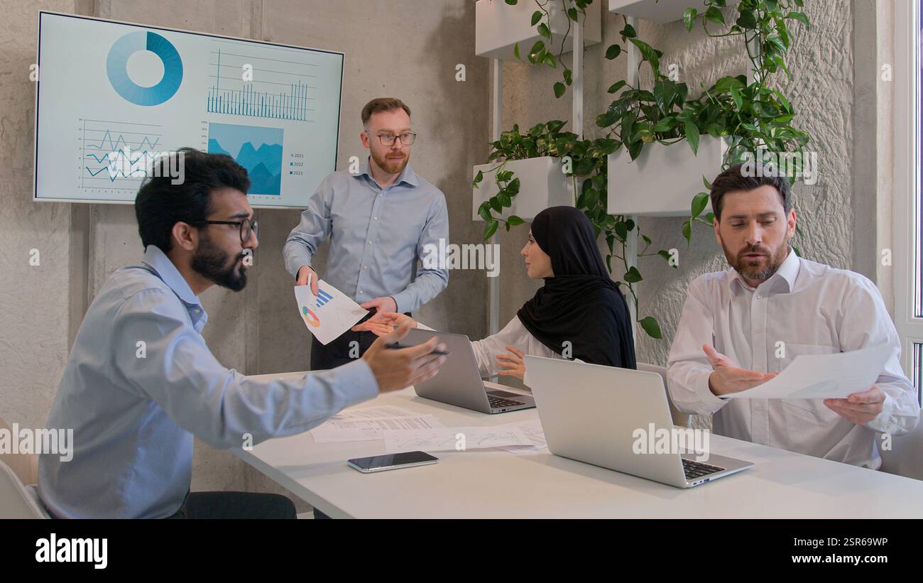 Emotional business team arguing at office discussing financial strategy ...