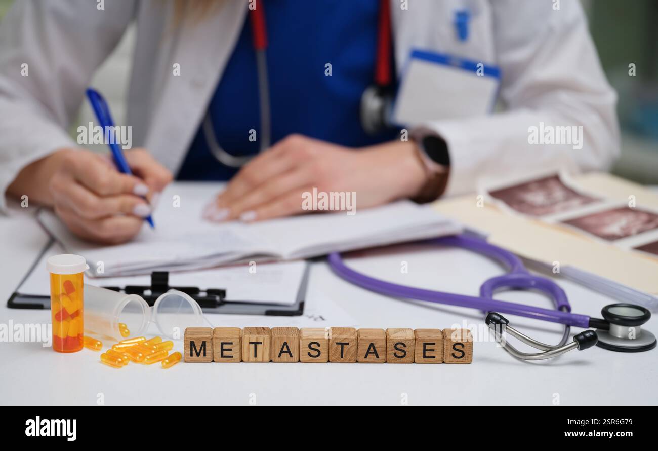 A dedicated doctor carefully writing detailed notes on metastases with ...