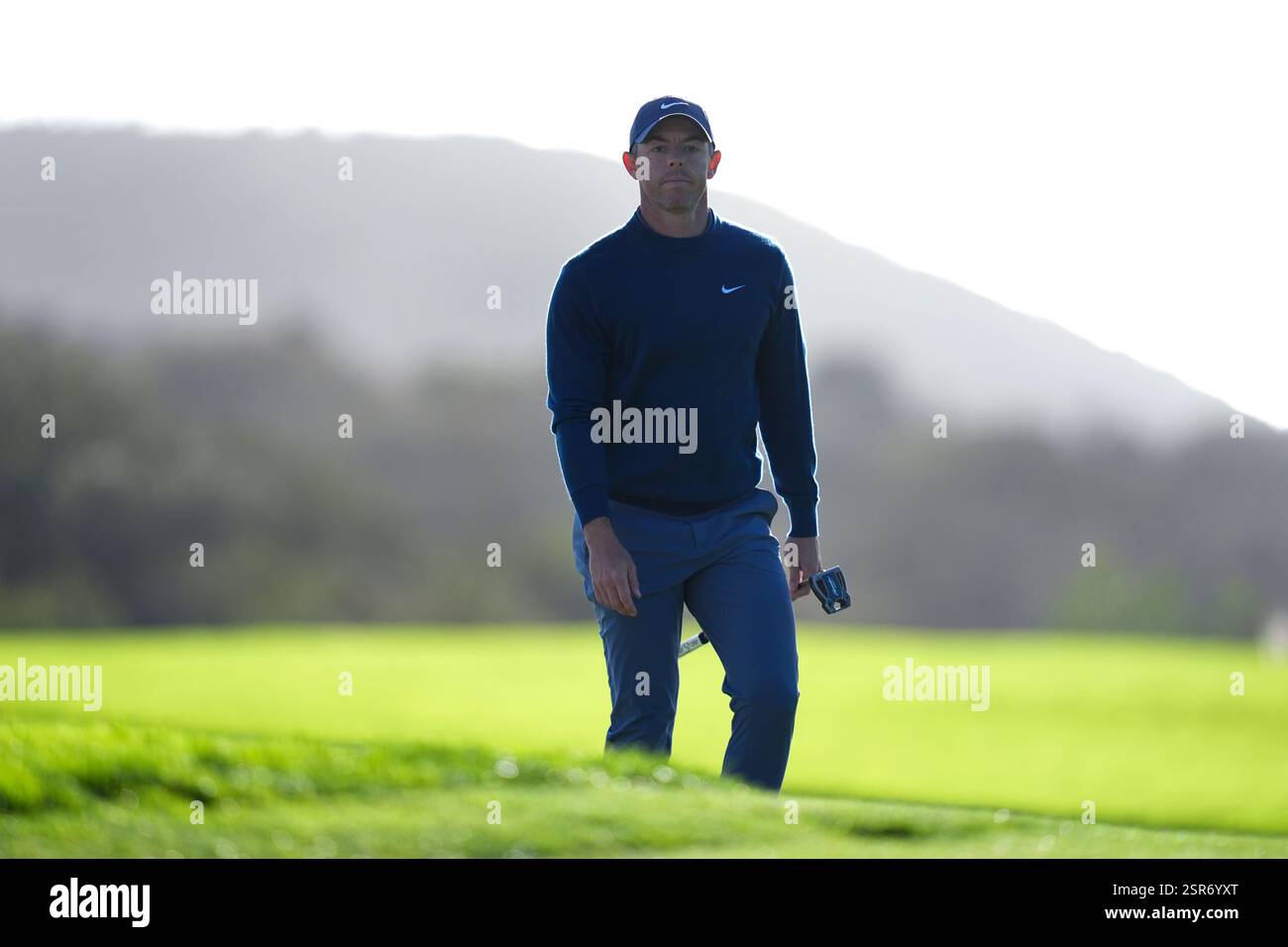 Rory McIlroy, of Northern Ireland, walks onto the green on the 17th ...