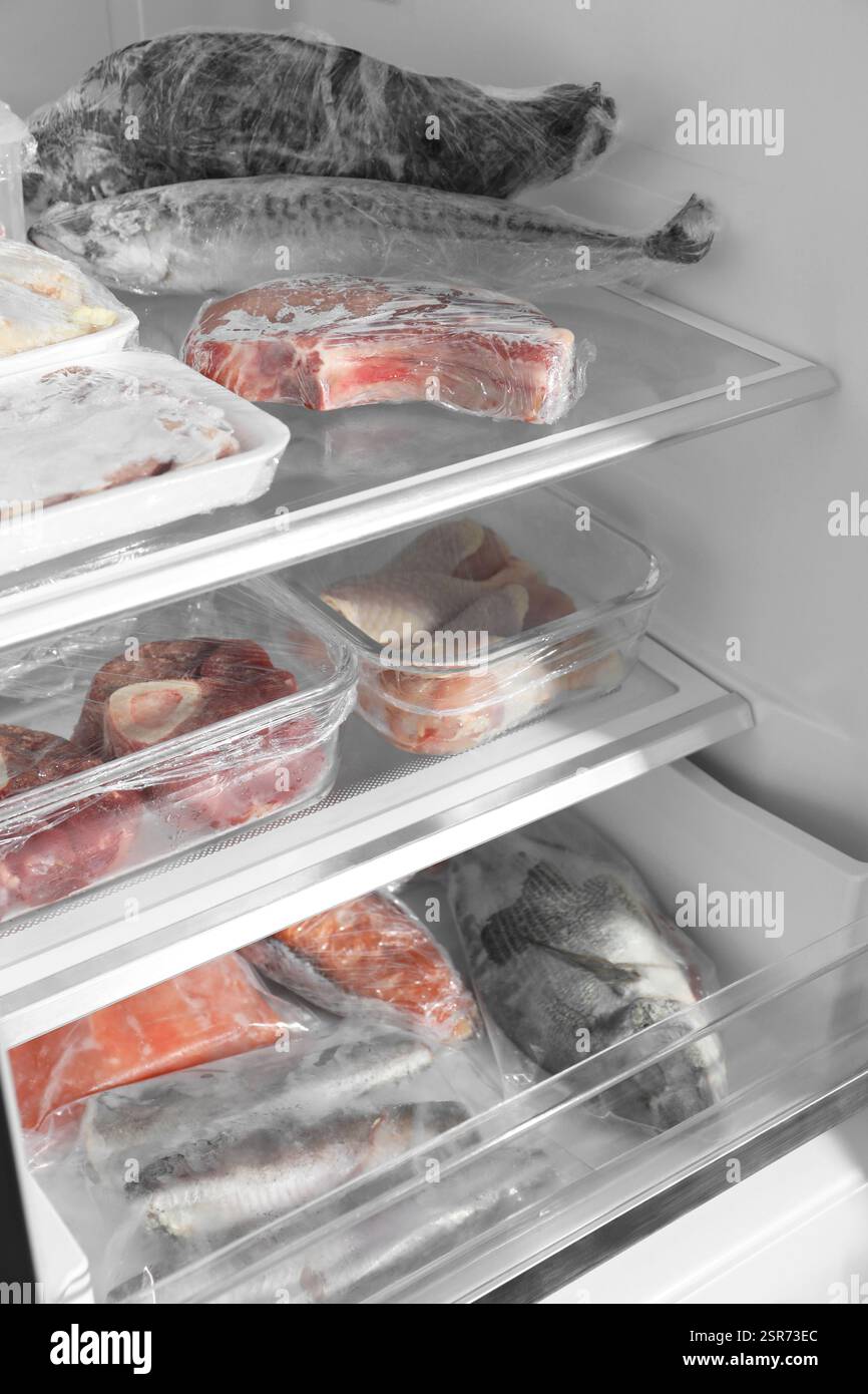 Different frozen meat and fish products in fridge Stock Photo - Alamy