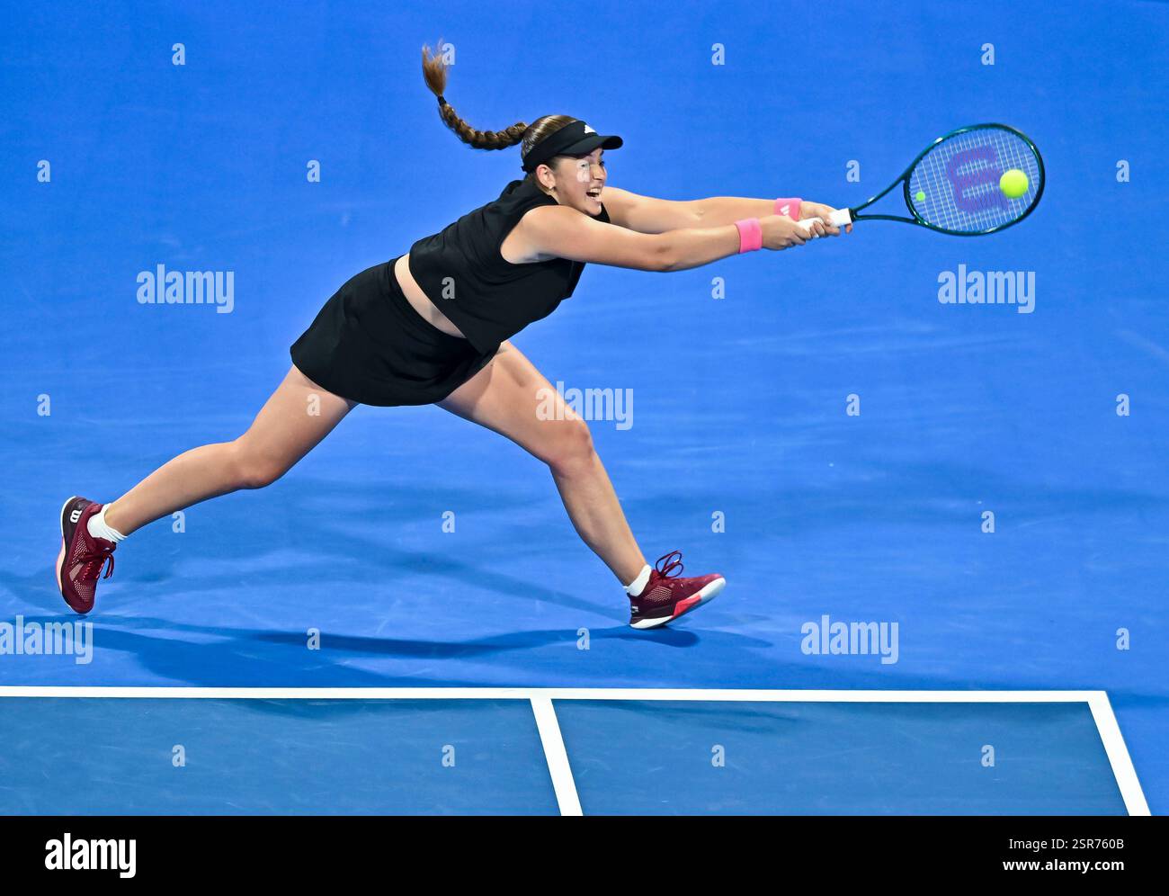 Doha, Qatar. 14th Feb, 2025. Jelena Ostapenko hits a return during the women's singles semi ...