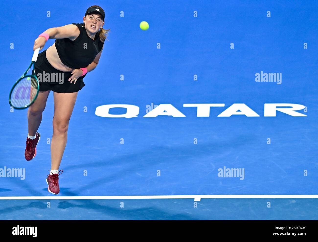 Doha, Qatar. 14th Feb, 2025. Jelena Ostapenko serves during the women's singles semi-final match ...