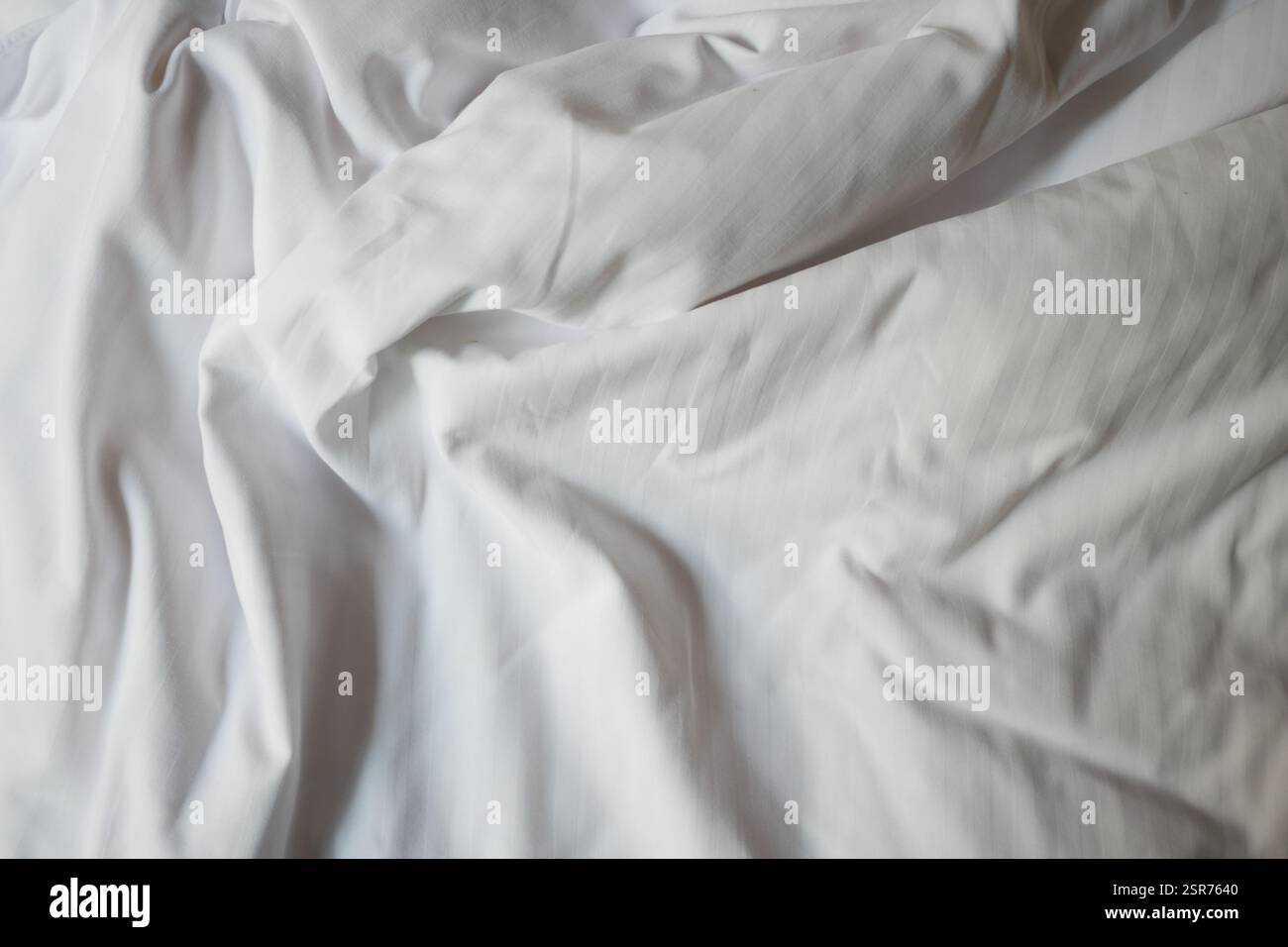Soft white fabric draped gracefully on a flat surface Stock Photo - Alamy
