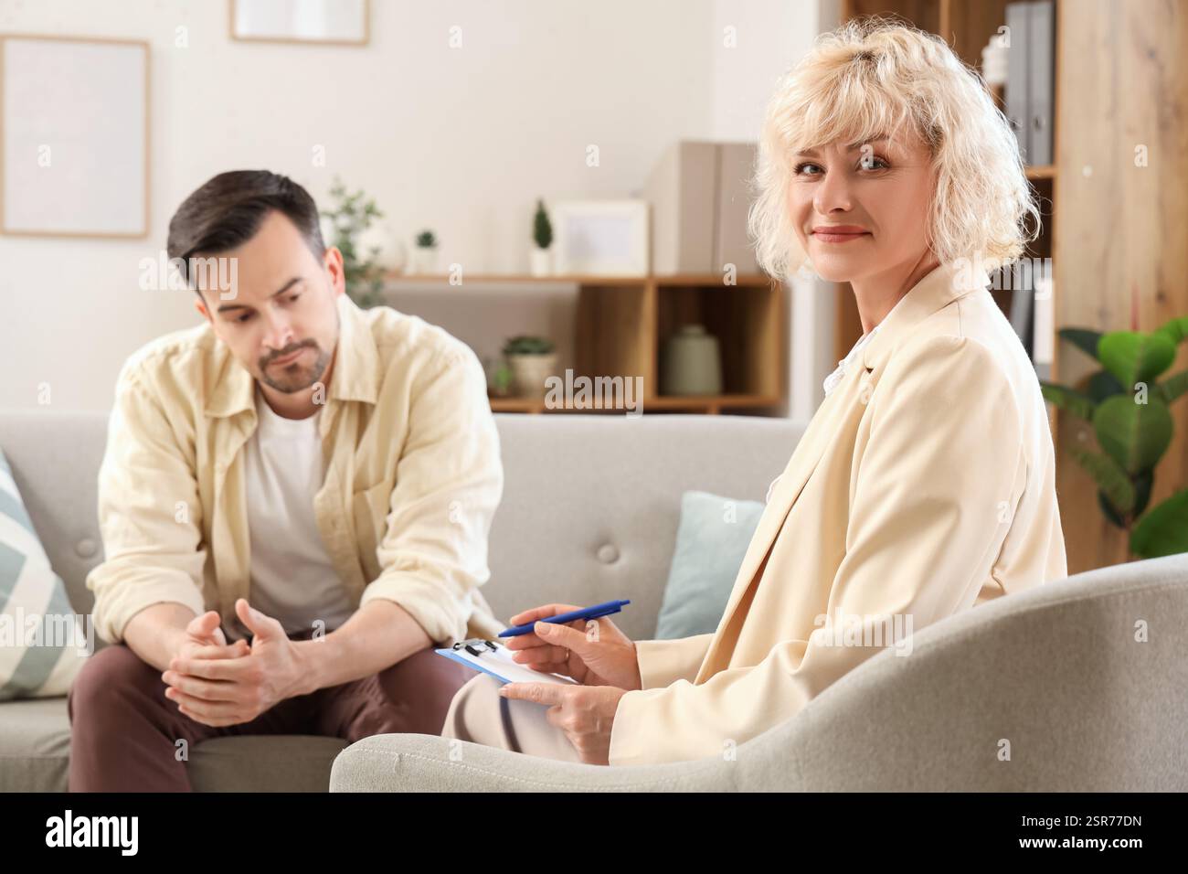 Female psychologist working with young man in office Stock Photo - Alamy