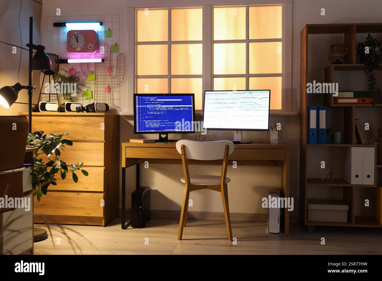 Interior of programmer's office with workplace, shelf unit and glowing ...