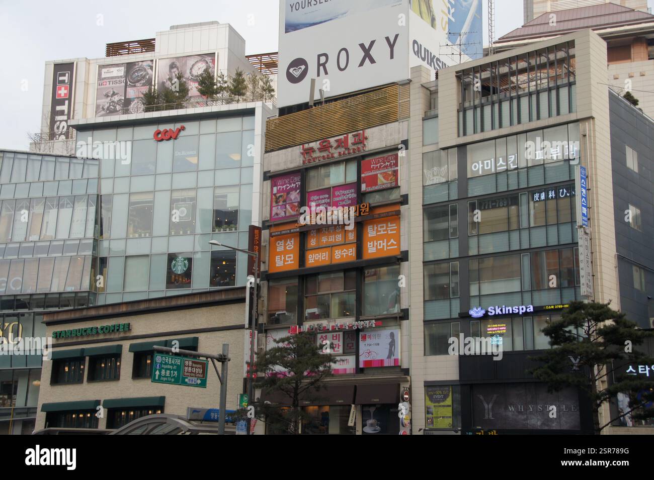 Korean cityscape. Multiple signs with Korean text. Buildings with glass ...