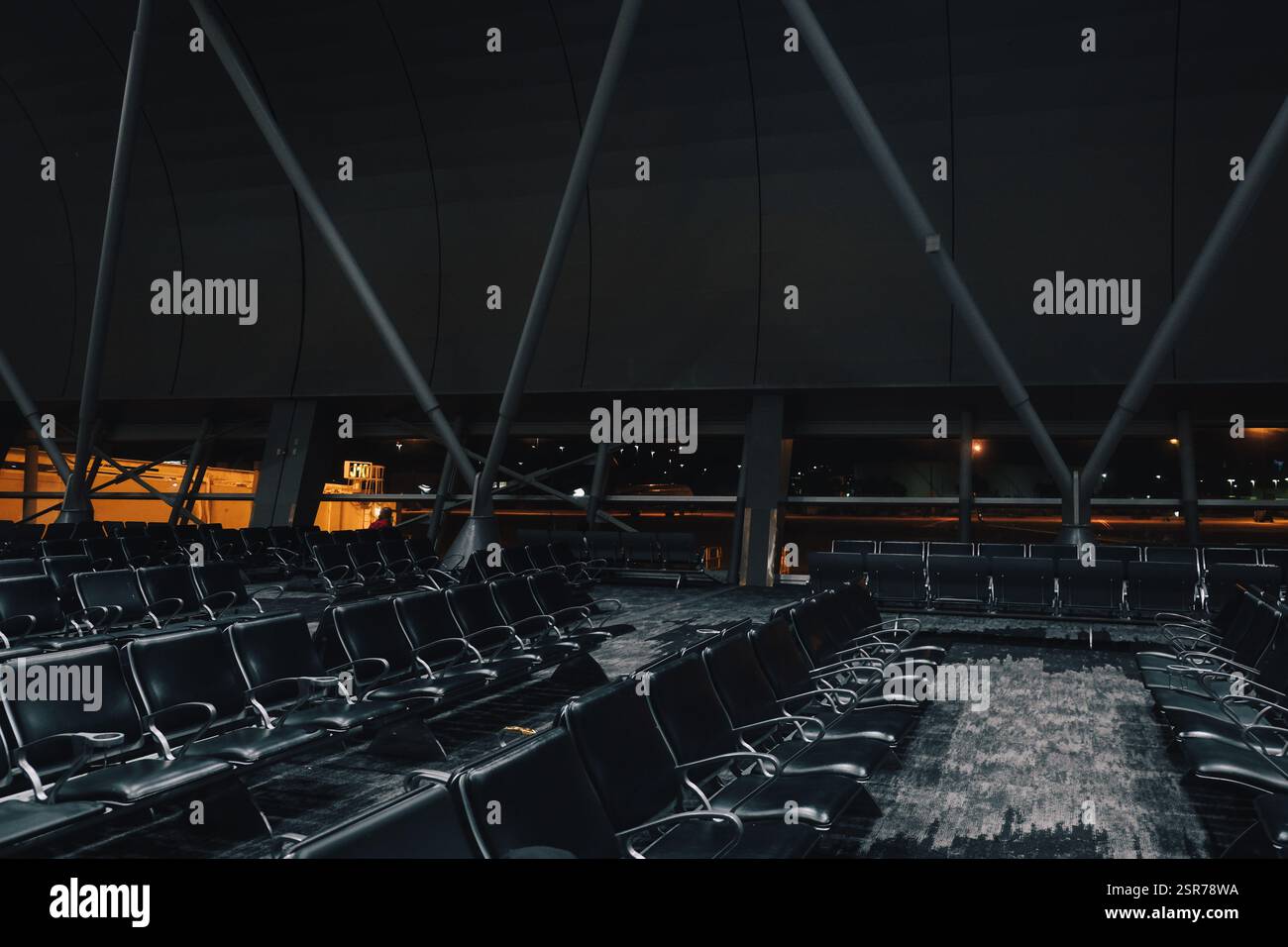 Empty Airport Lounge During Night Hours. Rows Of Black Seats In A Quiet ...