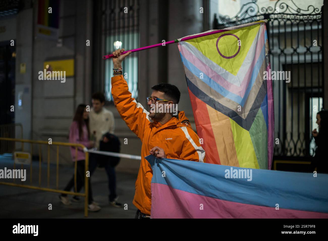 Madrid, Spain. 14th Feb, 2025. A protester waves an LGTBIQ flag in one ...