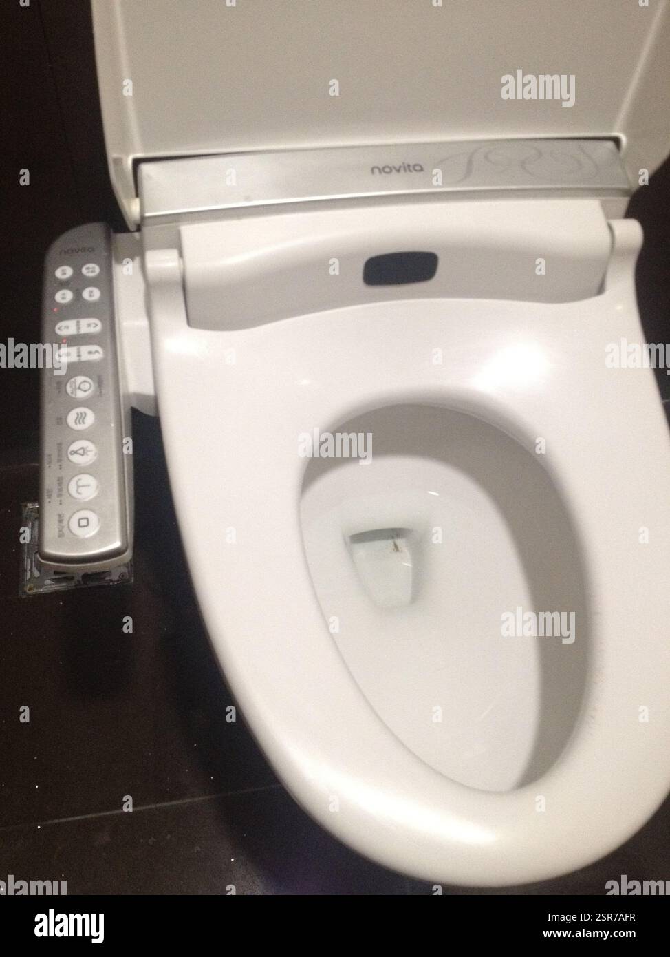 Toilet seat remote control. Lid open. Cleanliness hygiene comfort ...