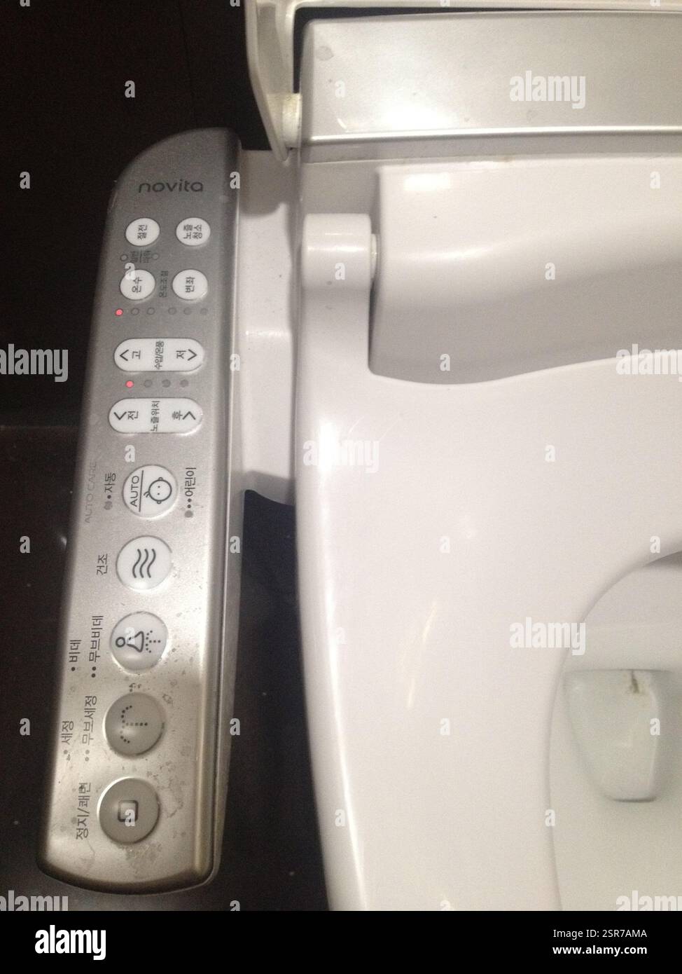 Toilet control panel with buttons for various functions. Korean text ...