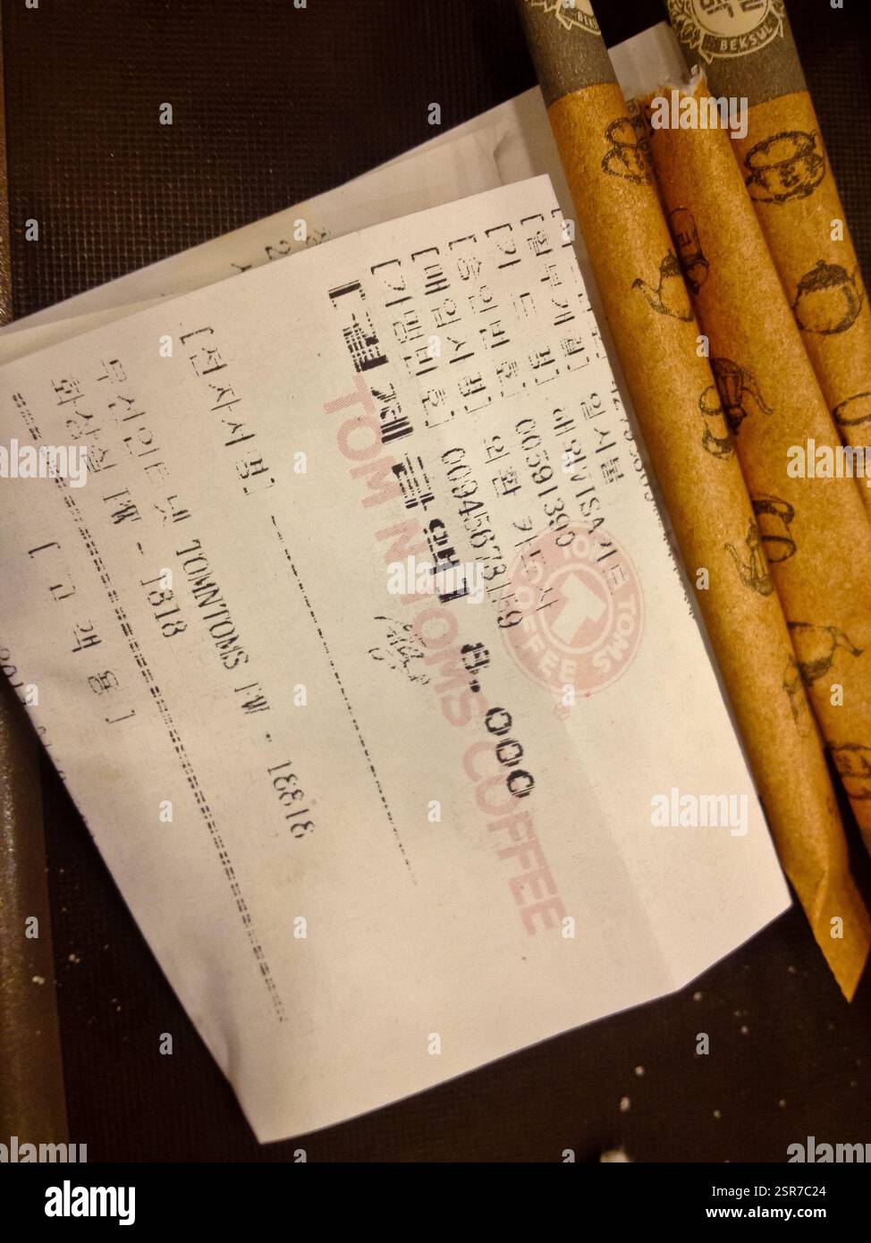 The receipt from TOMS COFFEE, South Korea, shows a transaction for ...