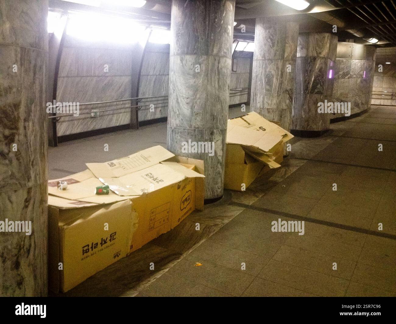 Subway platform in South Korea. Cardboard boxes scattered on the floor ...
