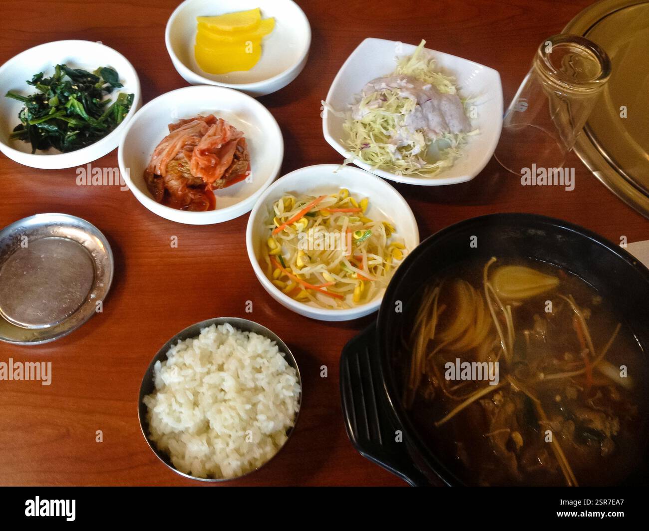 Korean BBQ table setting. Various side dishes including kimchi, spinach ...