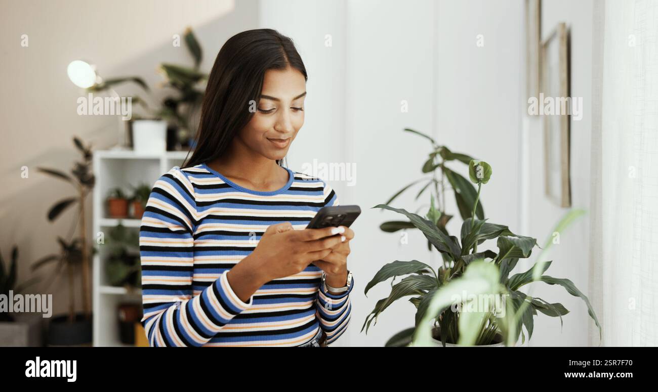 Phone, home and Indian woman with online application, social media and ...