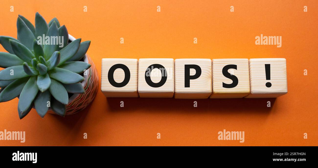 Oops symbol. Concept word Oops on wooden cubes. Beautiful orange ...
