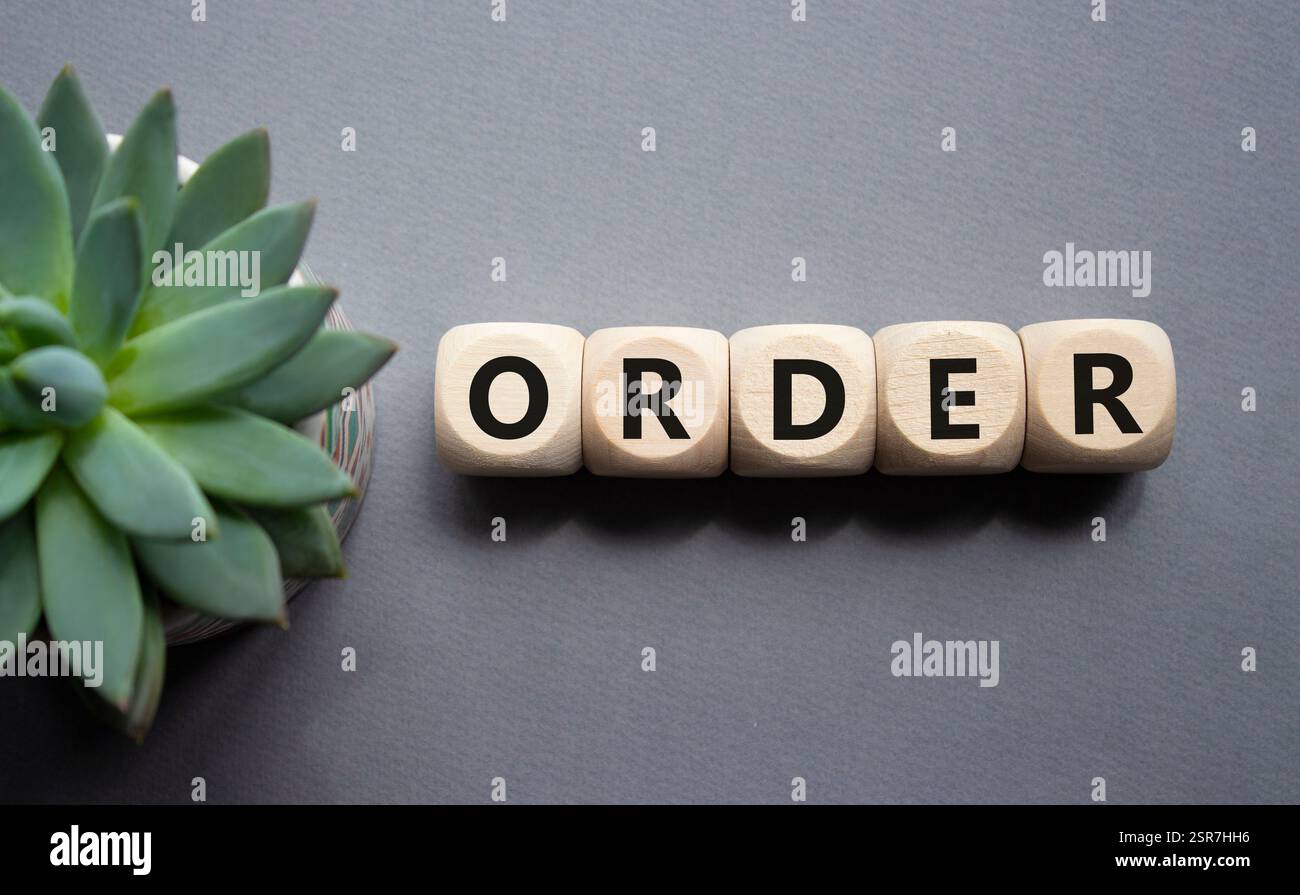 Order symbol. Wooden cubes with word Order. Beautiful grey background ...