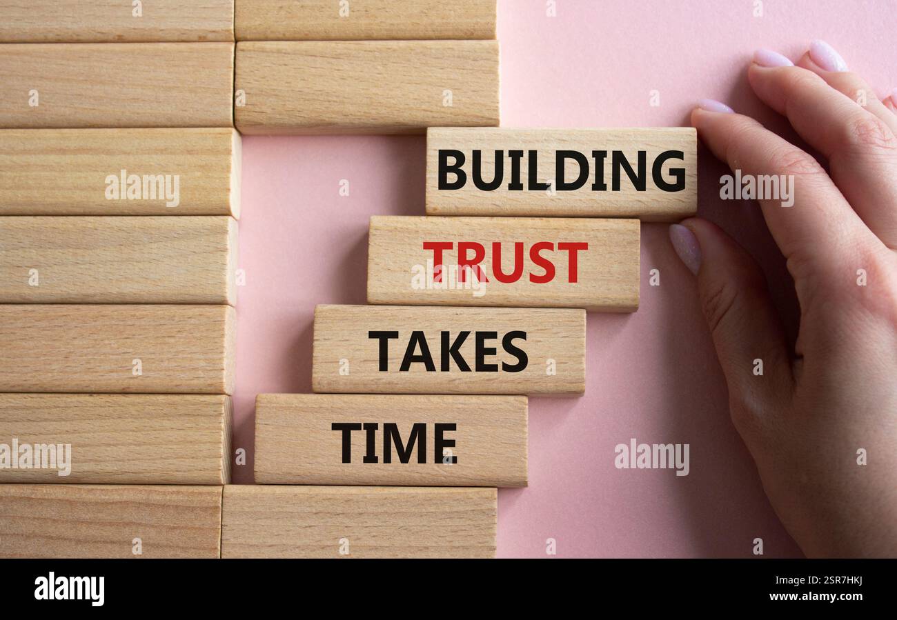 Building Trust takes Time symbol. Wooden blocks with words Building ...
