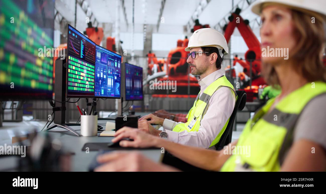 Diverse automotive team works together in factory using Scada system ...