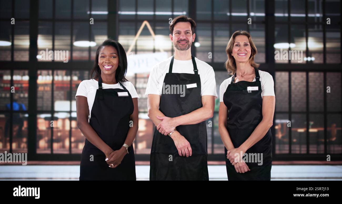 Portrait of restaurant manager and happy coffee shop workers serving ...