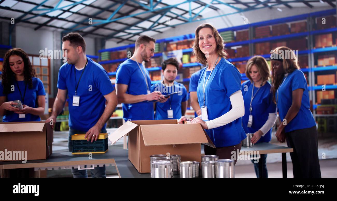 Diverse volunteers at charity foundation donate food to local community ...