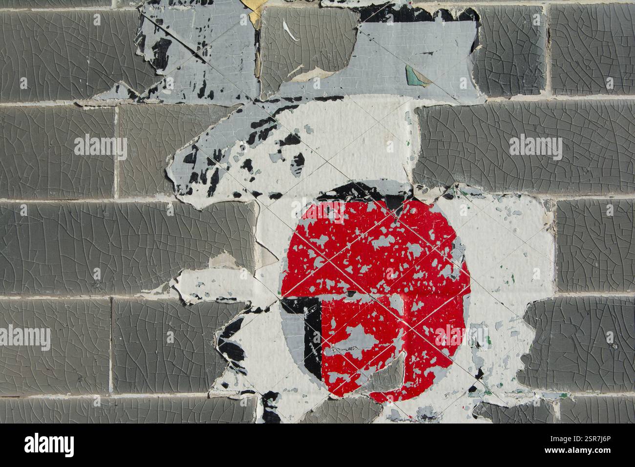 Texture and contrast, a worn out sign fragment against a cracked tile ...