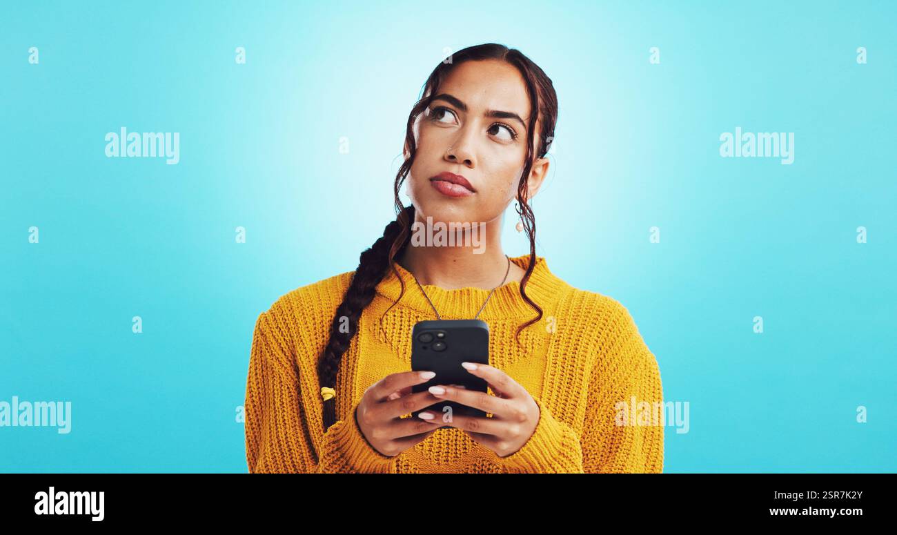 Girl, phone and thinking with texting in studio for web chat, contact ...