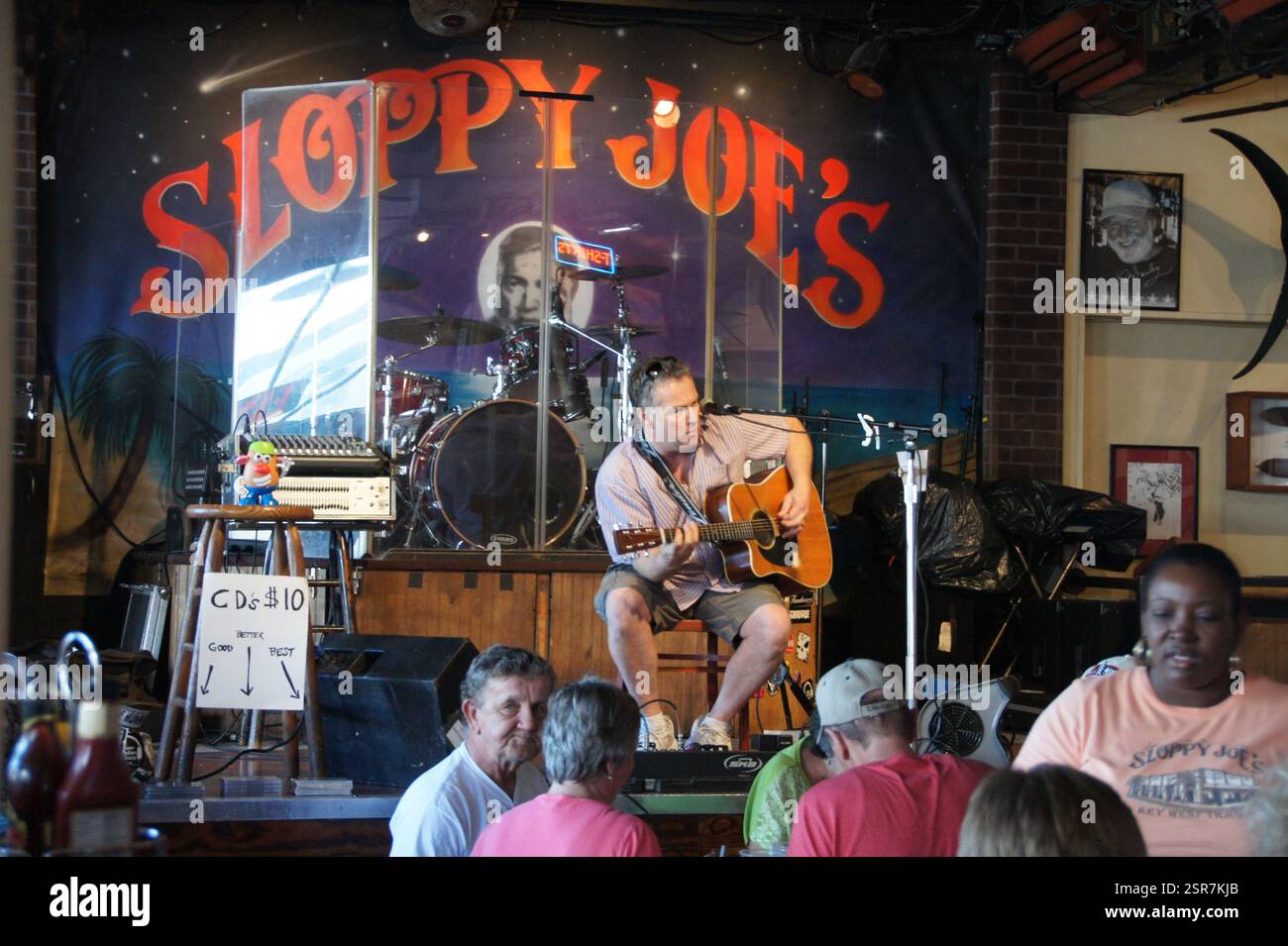 Sloppy Joe's Bar sign, worn and misspelled, hinting at neglect. Key ...