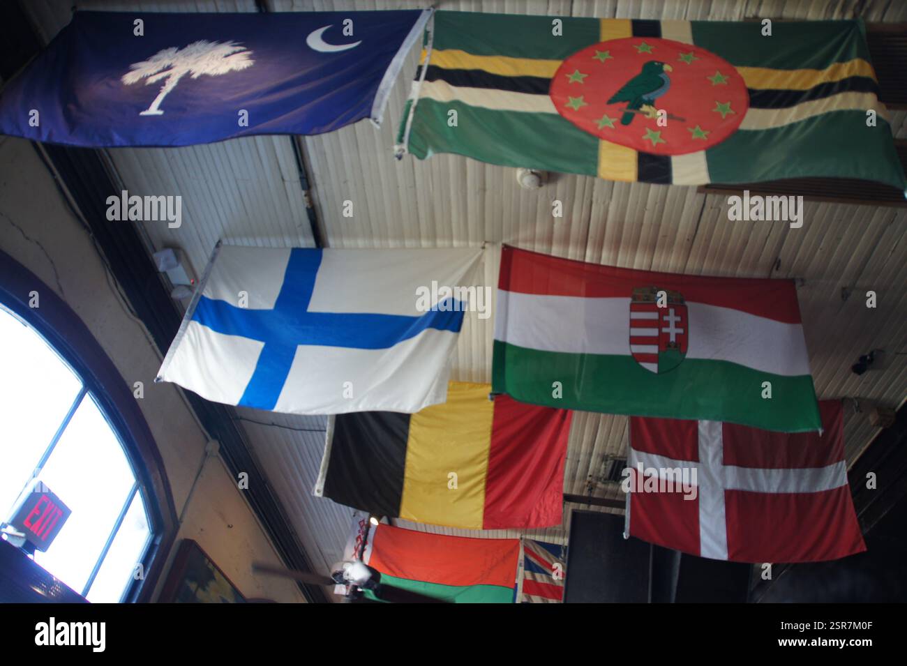 A vibrant tapestry of international flags adorns the Key West ceiling ...