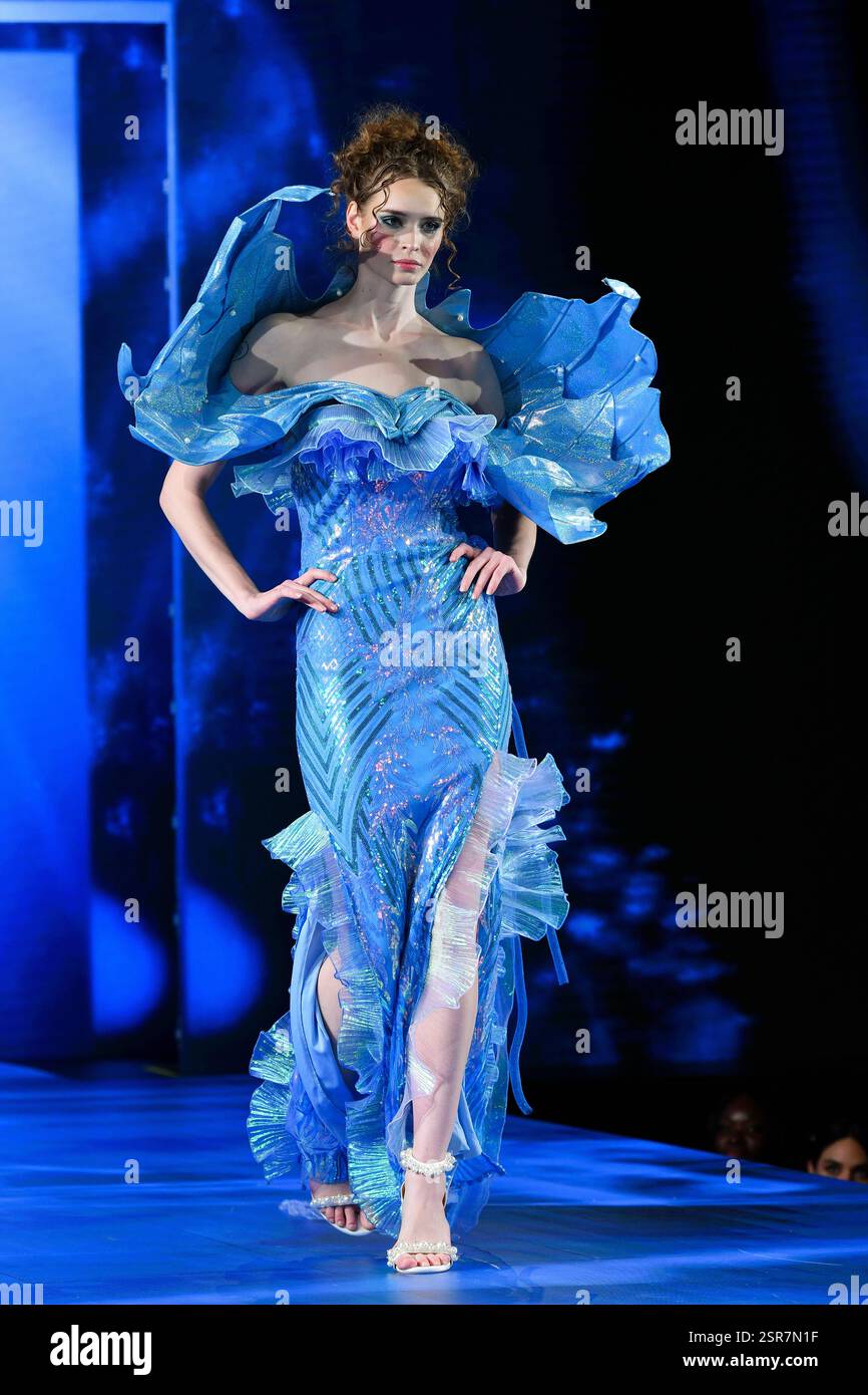 Model on the runway at NYFW 2025 in a blue couture gown with dramatic ...