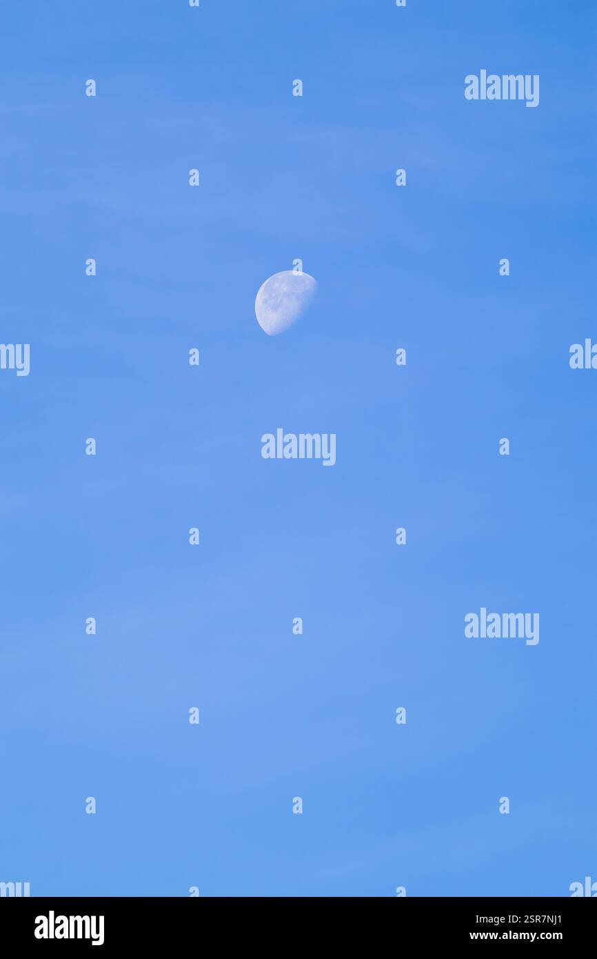 A clear image of a crescent moon visible during the daytime against a ...