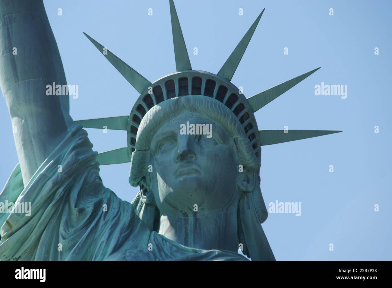 A close-up of the Statue of Liberty's copper crown with sun rays ...